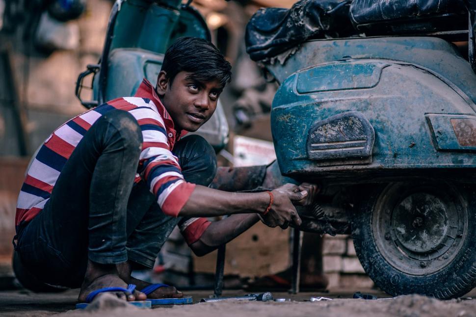 Free Stock Photo of Man Repairing Motorcycle on Street | Download Free ...