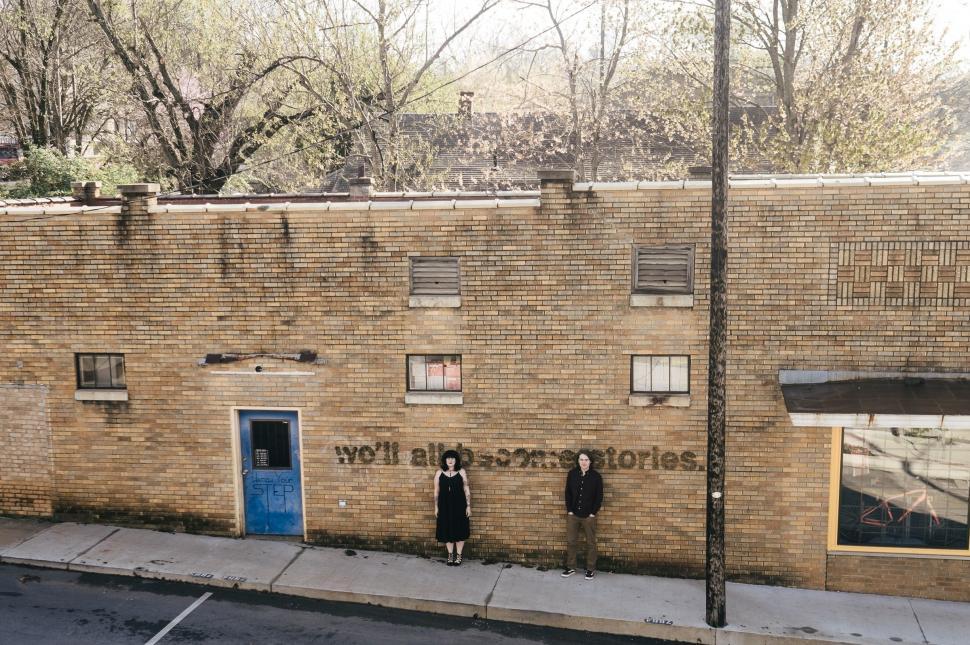 Free Stock Photo of Two People Standing in Front of a Brick Building ...