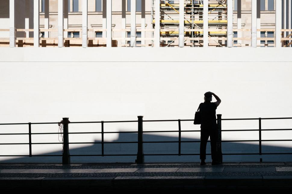 Free Stock Photo of Person Standing Next to Fence With Building in ...