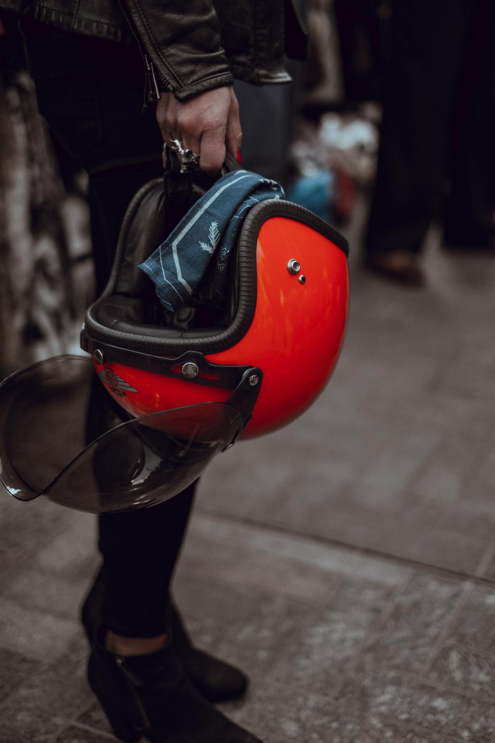 Free Stock Photo of Person Holding Motorcycle Helmet on Sidewalk ...