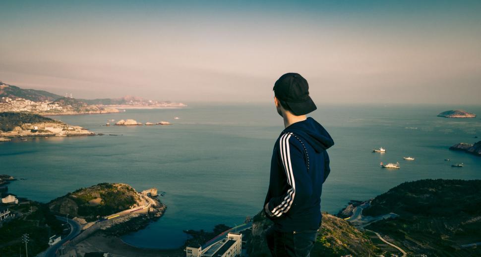 Free Stock Photo of Man Standing on Cliff Overlooking Water | Download ...