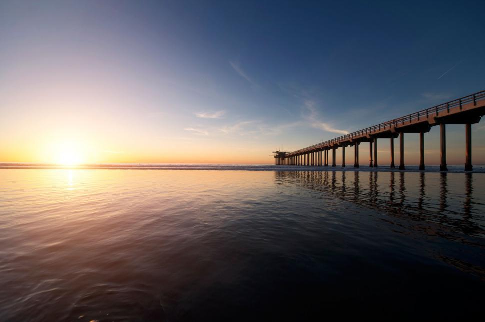Free Stock Photo of Sun Setting Over Water Near Pier | Download Free ...