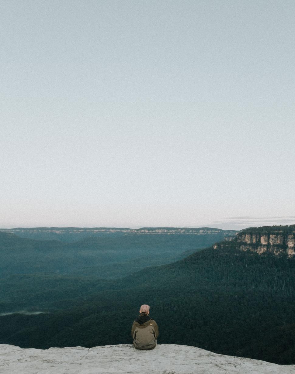 Free Stock Photo of Person Sitting on Top of a Mountain Overlooking ...