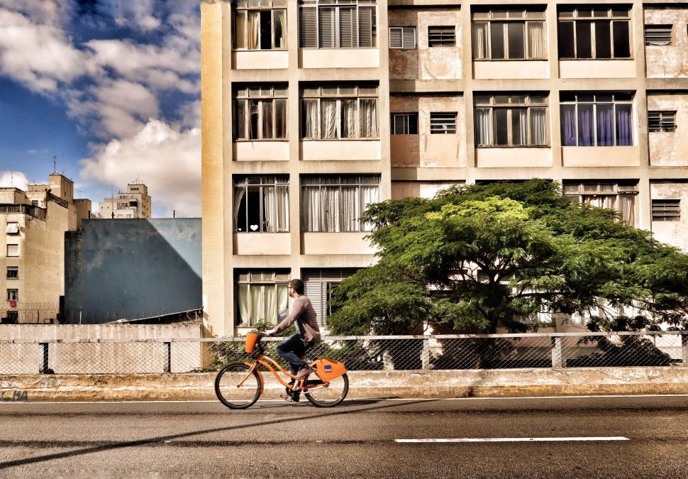 Free Stock Photo of Man Riding Bike Down City Street | Download Free ...