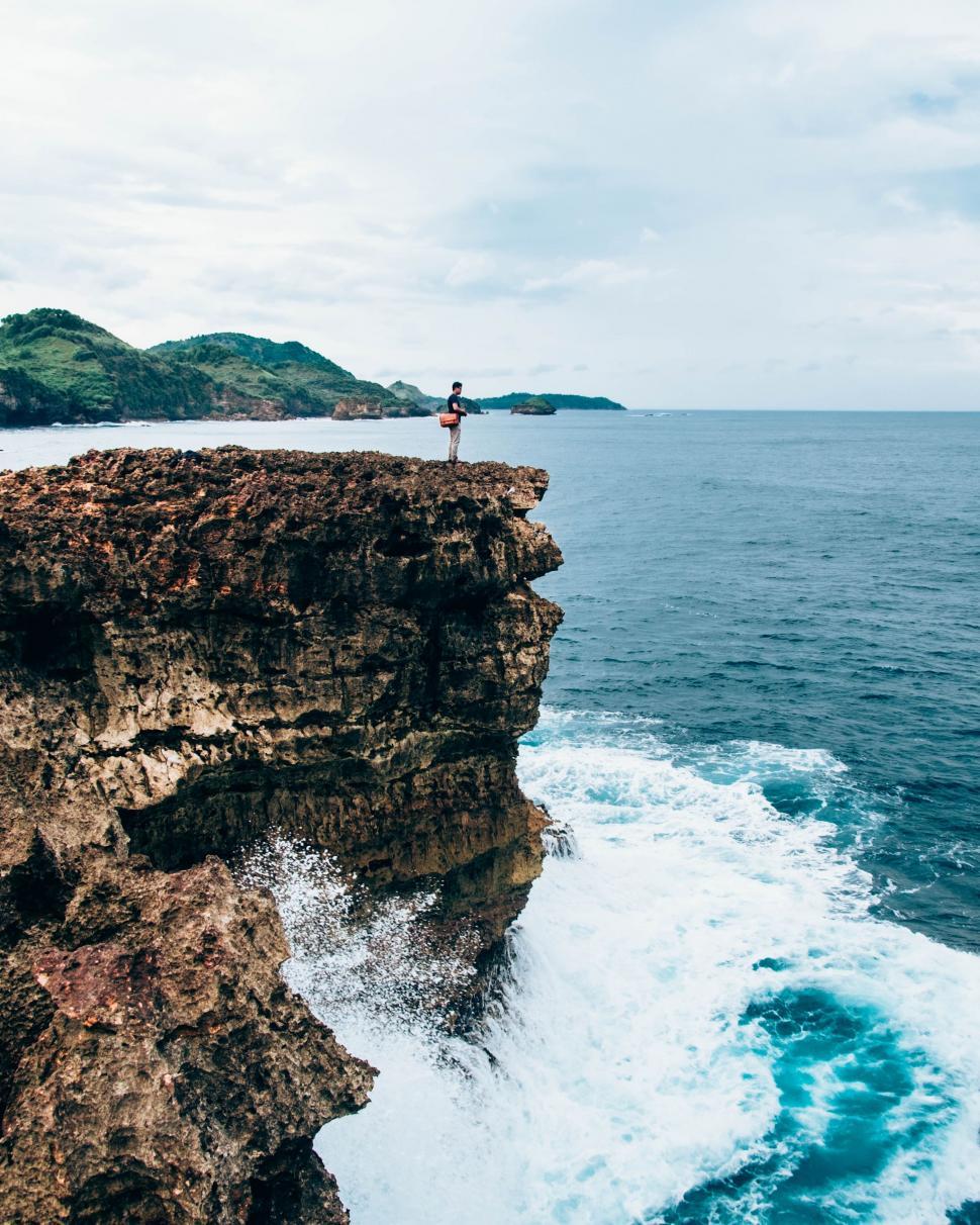 Free Stock Photo of Person Standing on Cliff Near Ocean | Download Free ...