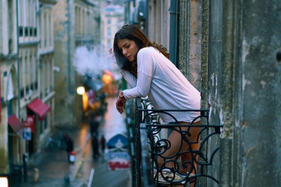 Free Stock Photo of Woman Standing on Balcony Smoking a Cigarette ...