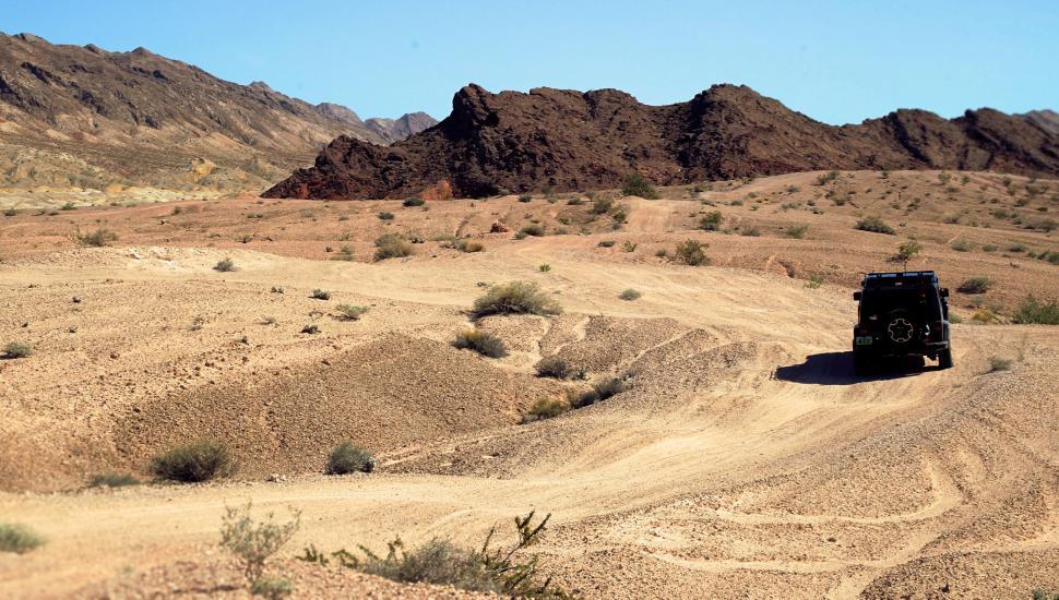 Free Stock Photo of Jeep Driving Through Desert With Mountains in ...