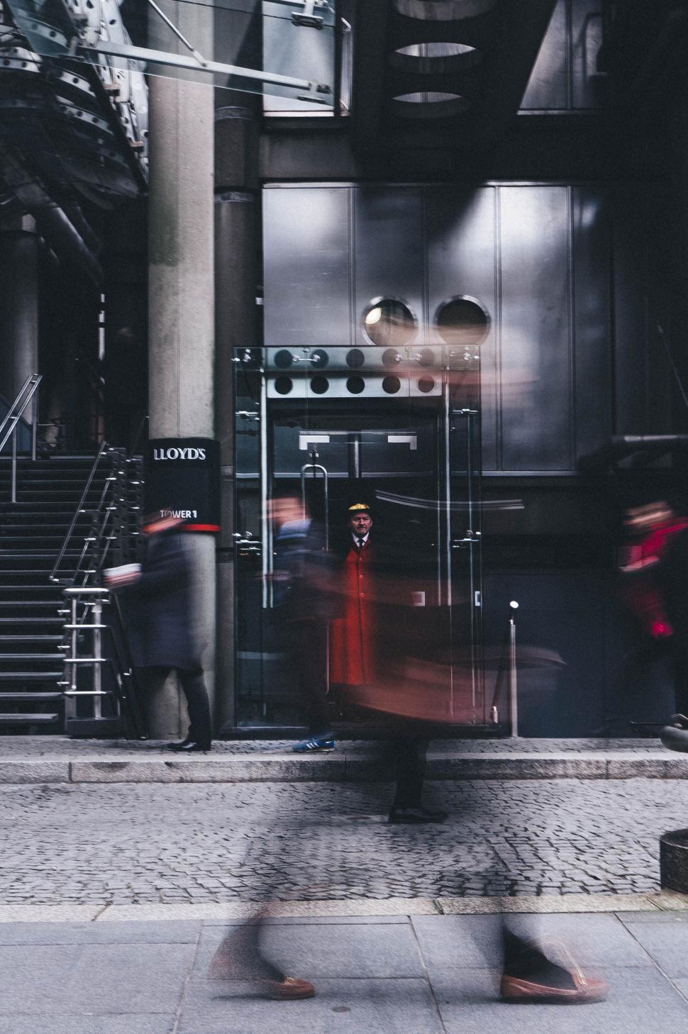 Free Stock Photo of Man Walking Down a Street Next to a Tall Building ...