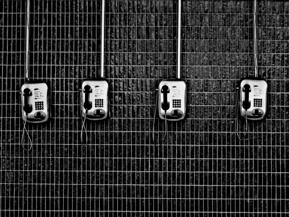 Free Stock Photo of Row of Four Cell Phones Mounted to Wall | Download ...