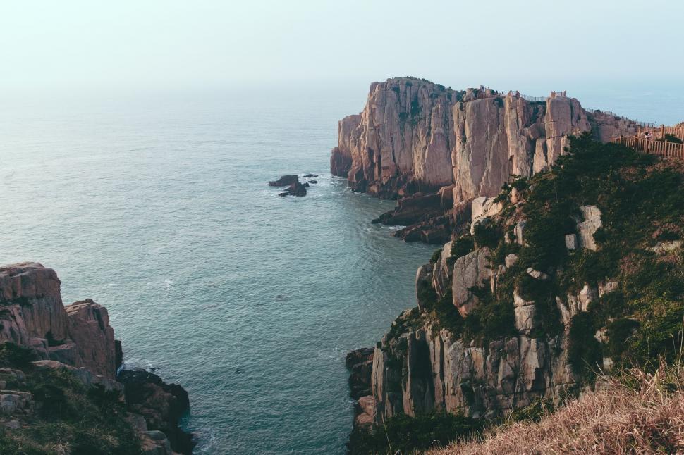 Free Stock Photo of Rocky Cliff Next to Large Body of Water | Download ...