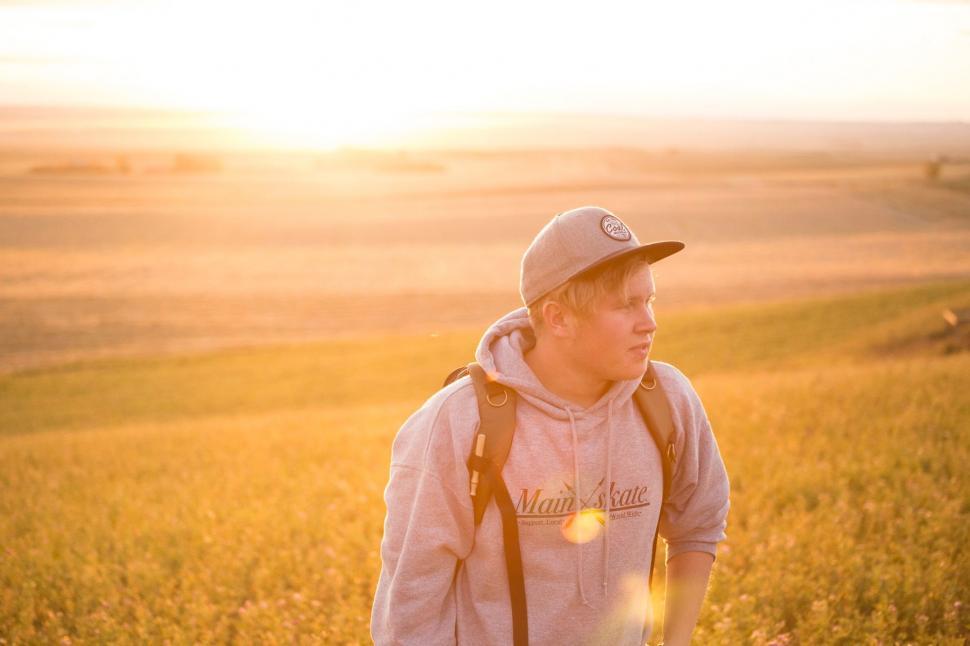 Free Stock Photo of Young Man Standing in Tall Grass Field | Download ...