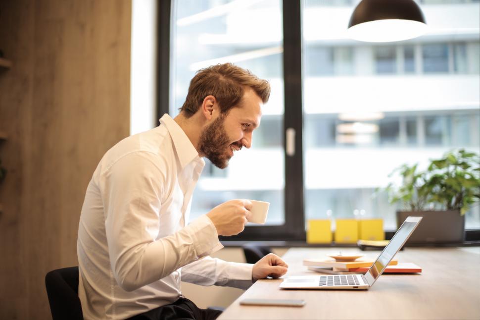 Free Stock Photo of A young bearded caucasian man looking at his laptop ...