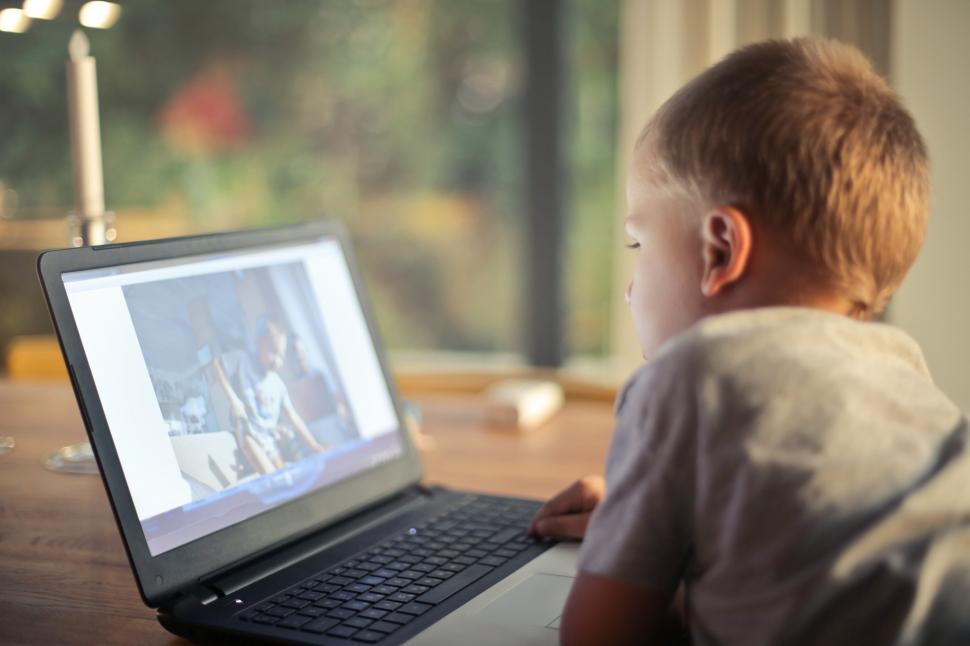 Free Stock Photo of A young caucasian child watching movie on laptop ...