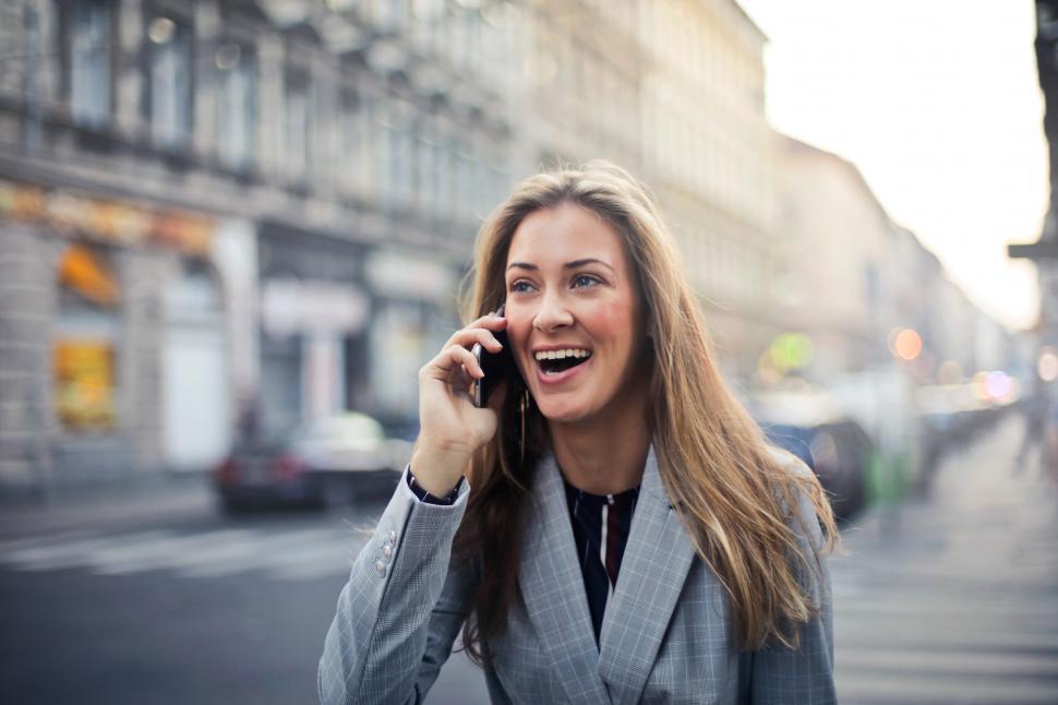 Free Stock Photo of A young blonde woman calling on her mobile phone in ...