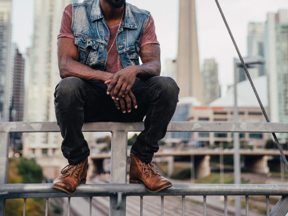 Free Stock Photo of A young man sitting on a metal railing | Download ...