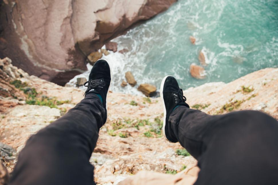 Free Stock Photo of Feet hanging over the edge of a layered rock ...