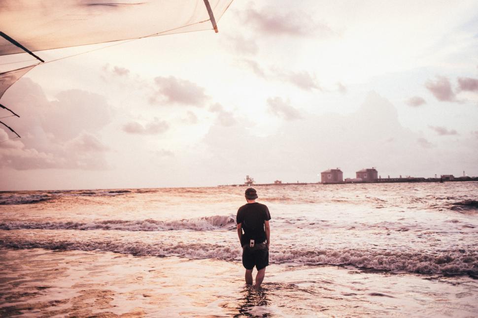 Free Stock Photo of A young caucasian man wading in sea water ...