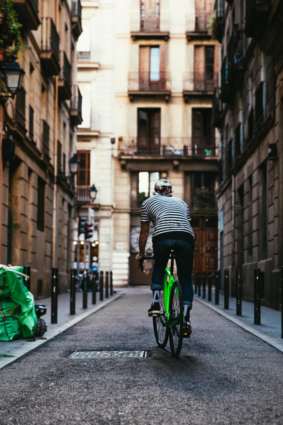 Free Stock Photo of Rear view of a biker riding a green bicycle ...