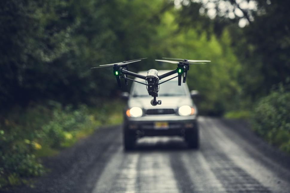Free Stock Photo of A drone flying flying over the road | Download Free ...