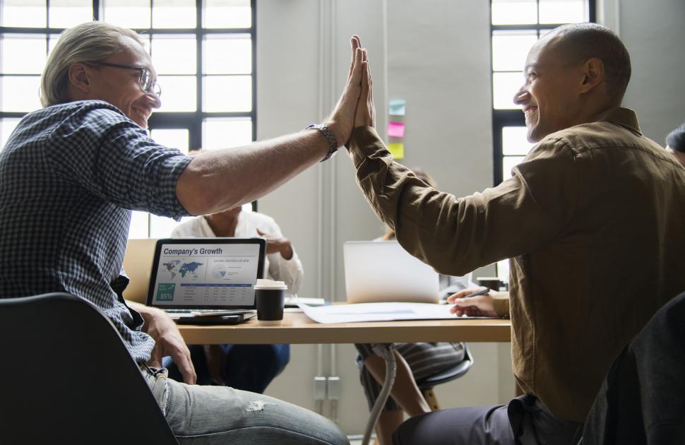 Free Stock Photo of Seated coworkers giving high five in the office ...