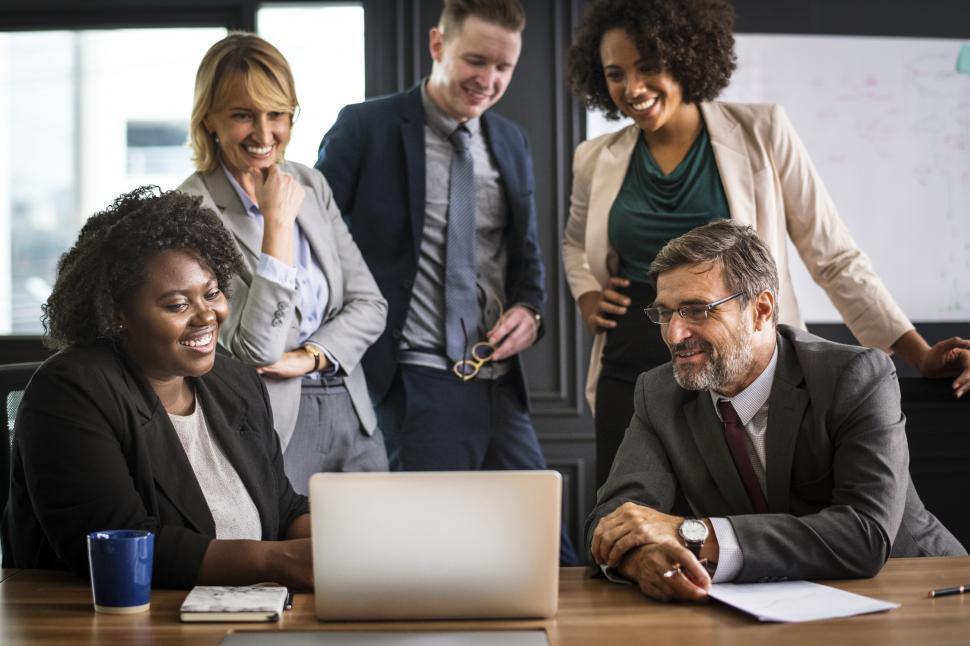 Free Stock Photo of Gathered around a laptop in a meeting | Download ...