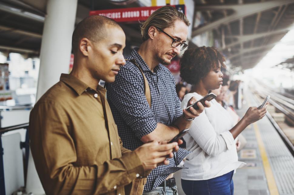 Free Stock Photo of Commuters looking at their mobile phones on a train ...