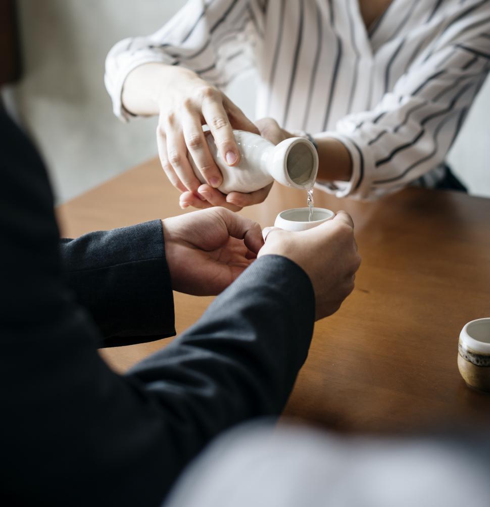 Free Stock Photo of Close up of hands pouring sake into Japanese ...