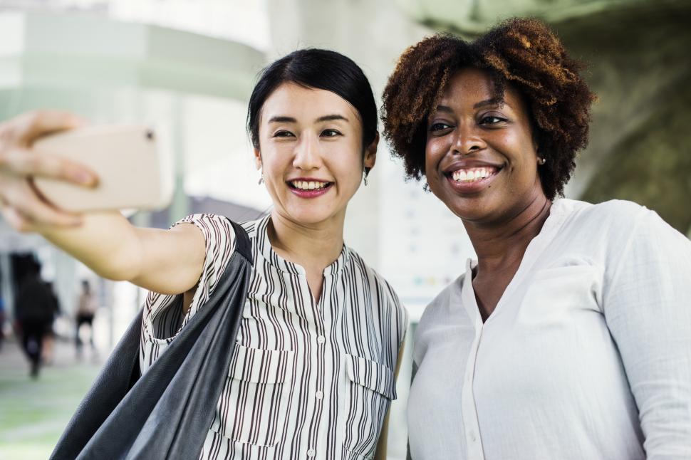 Free Stock Photo of Two smiling young women taking a selfie with mobile ...
