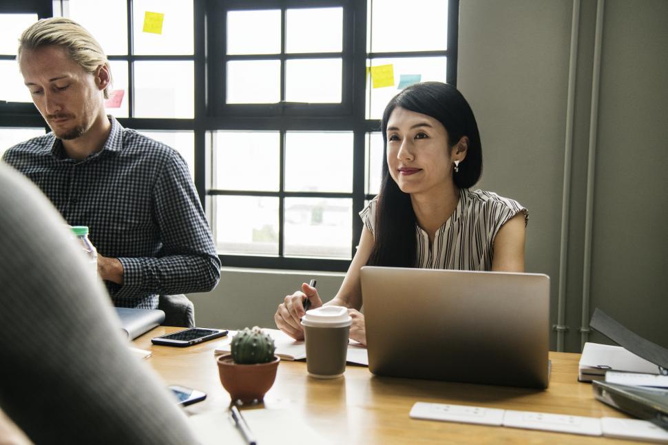 Free Stock Photo of Two colleagues in the office at shared work table ...