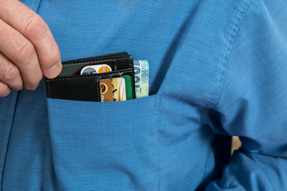Free Stock Photo of A Man in Blue Shirt Holding a Wallet | Download ...