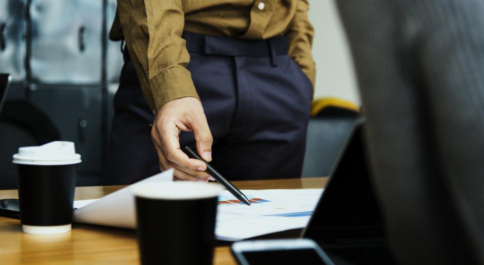 Free Stock Photo of Anonymous businessman pointing at a graph on the ...