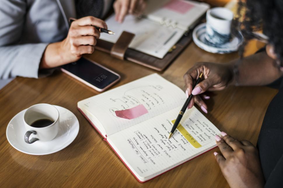 Free Stock Photo of Anonymous womans hand taking notes at a cafe table ...