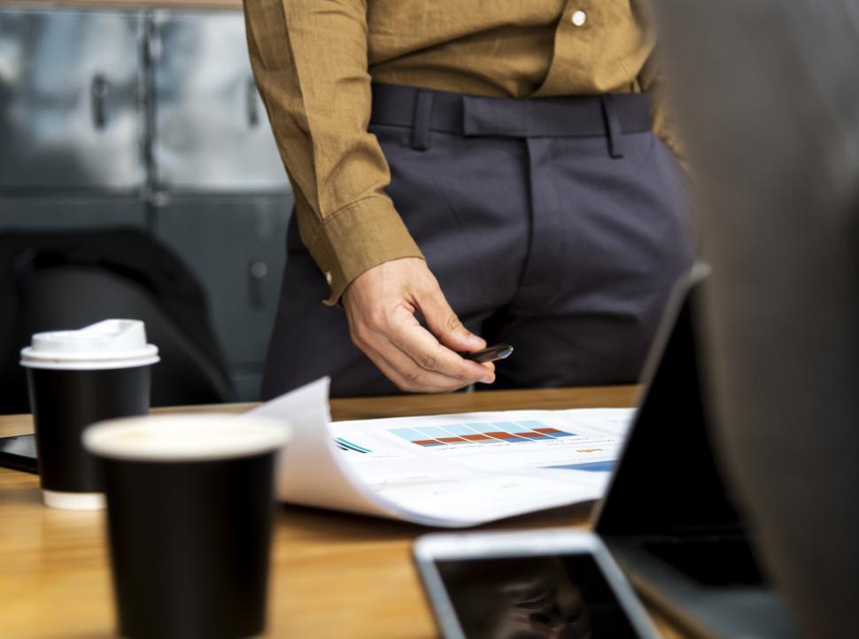 Free Stock Photo of Businessman pointing at a graph on the table ...