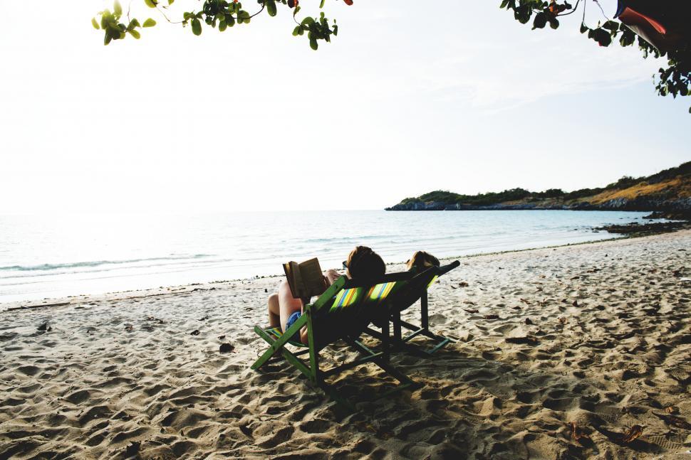 Free Stock Photo of A young woman reading book on the beach | Download ...