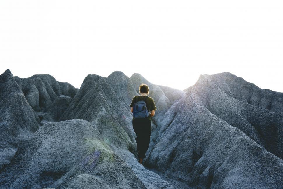 Free Stock Photo of A young woman outdoors taking photo on a bumpy hike ...