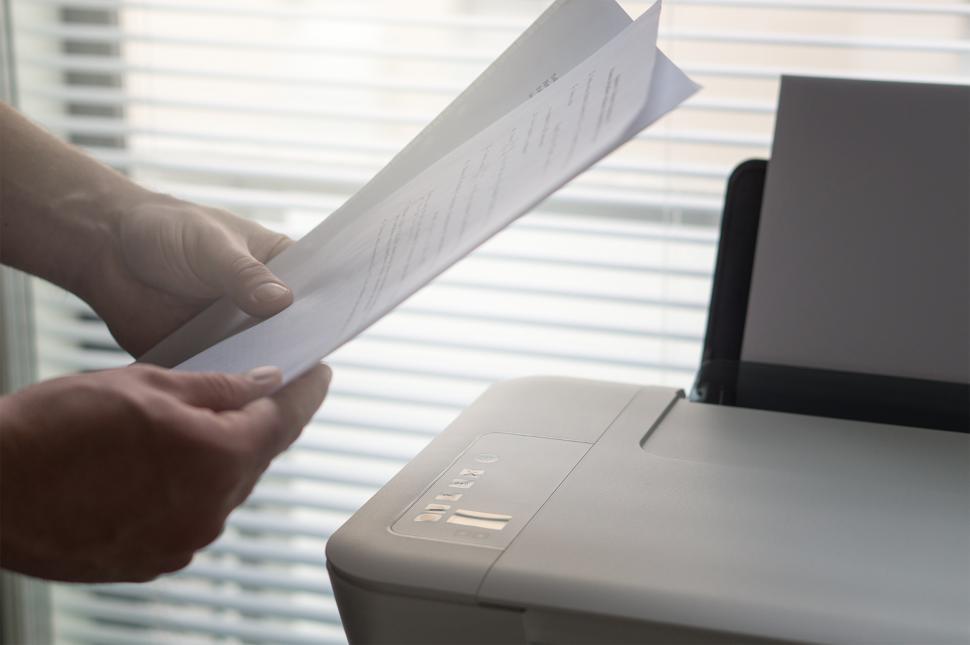 Free Stock Photo of Hands holding printed sheets over a printer ...