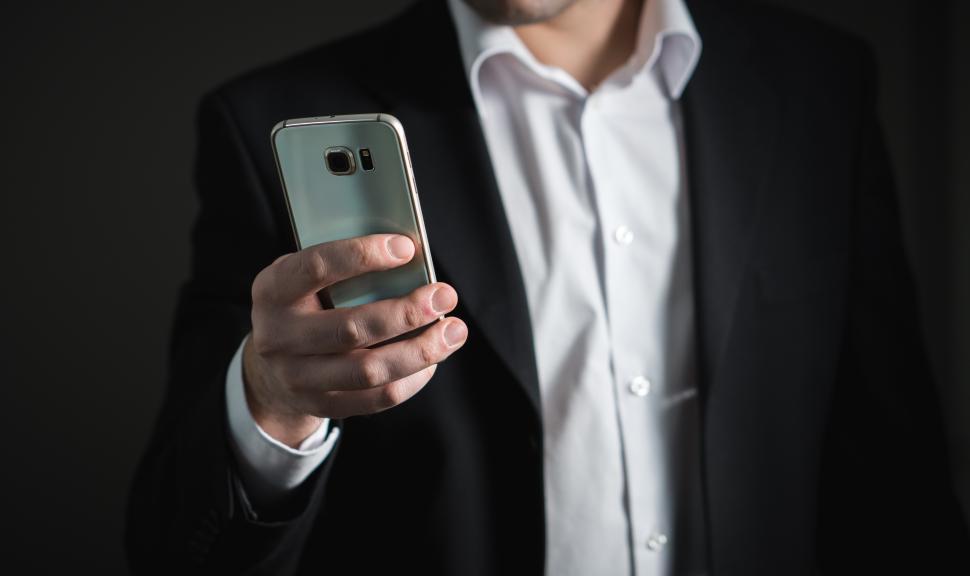 Free Stock Photo of Close up of a business person viewing his mobile ...