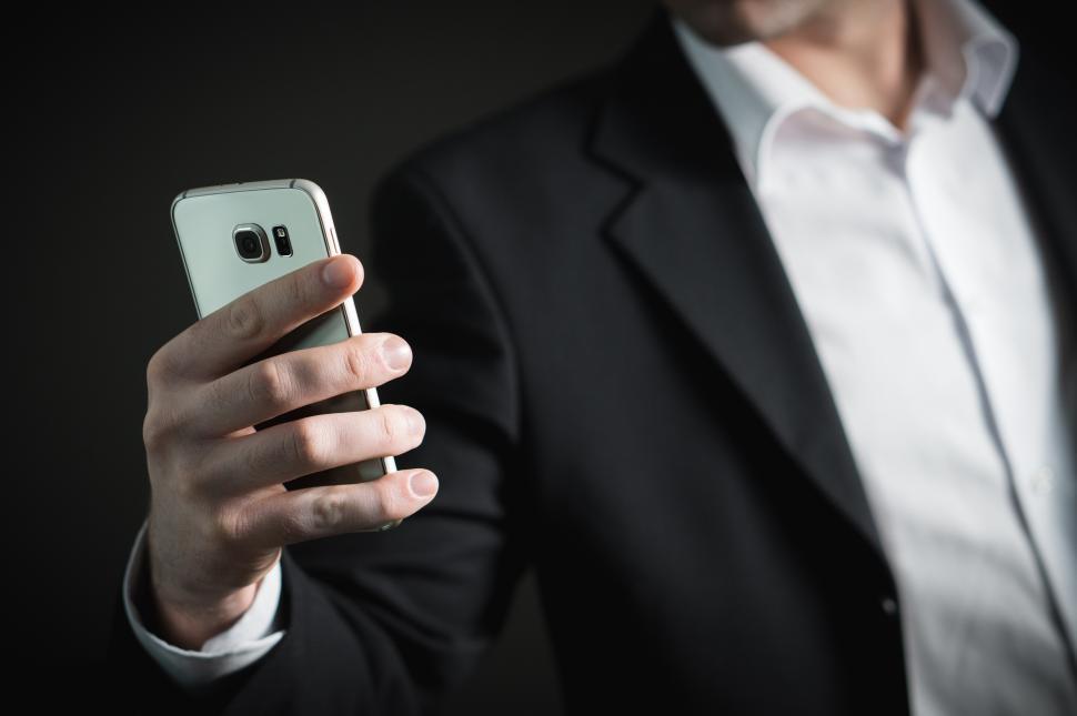 Free Stock Photo of Close up of a business person looking at mobile ...