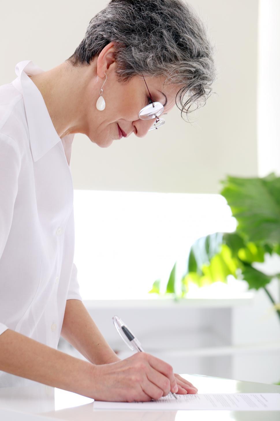 Free Stock Photo of Happy mature woman writing | Download Free Images ...