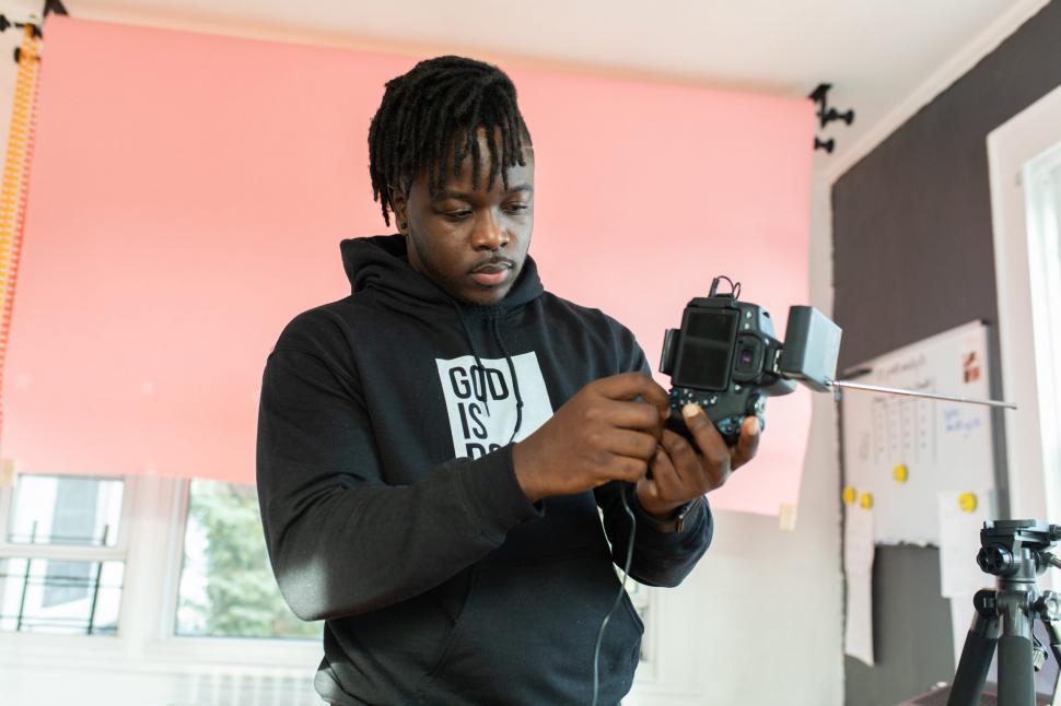 Free Stock Photo of Young Man With Professional Camera at workplace ...