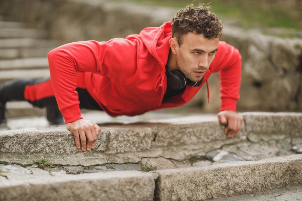 Free Stock Photo of Male athlete with headphones on neck doing push-ups ...
