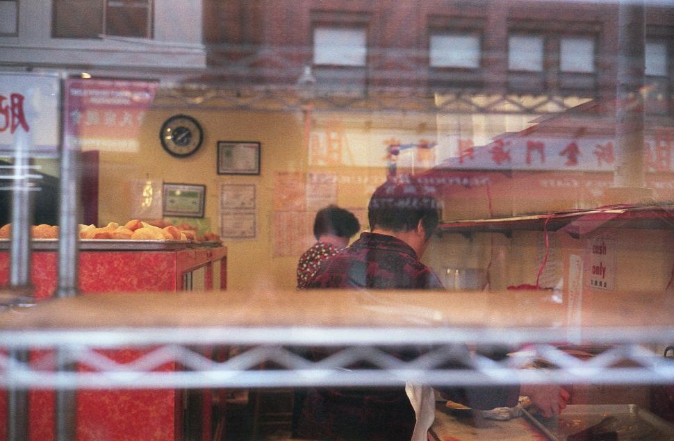 Free Stock Photo of Glass door of restaurant with workers in kitchen ...