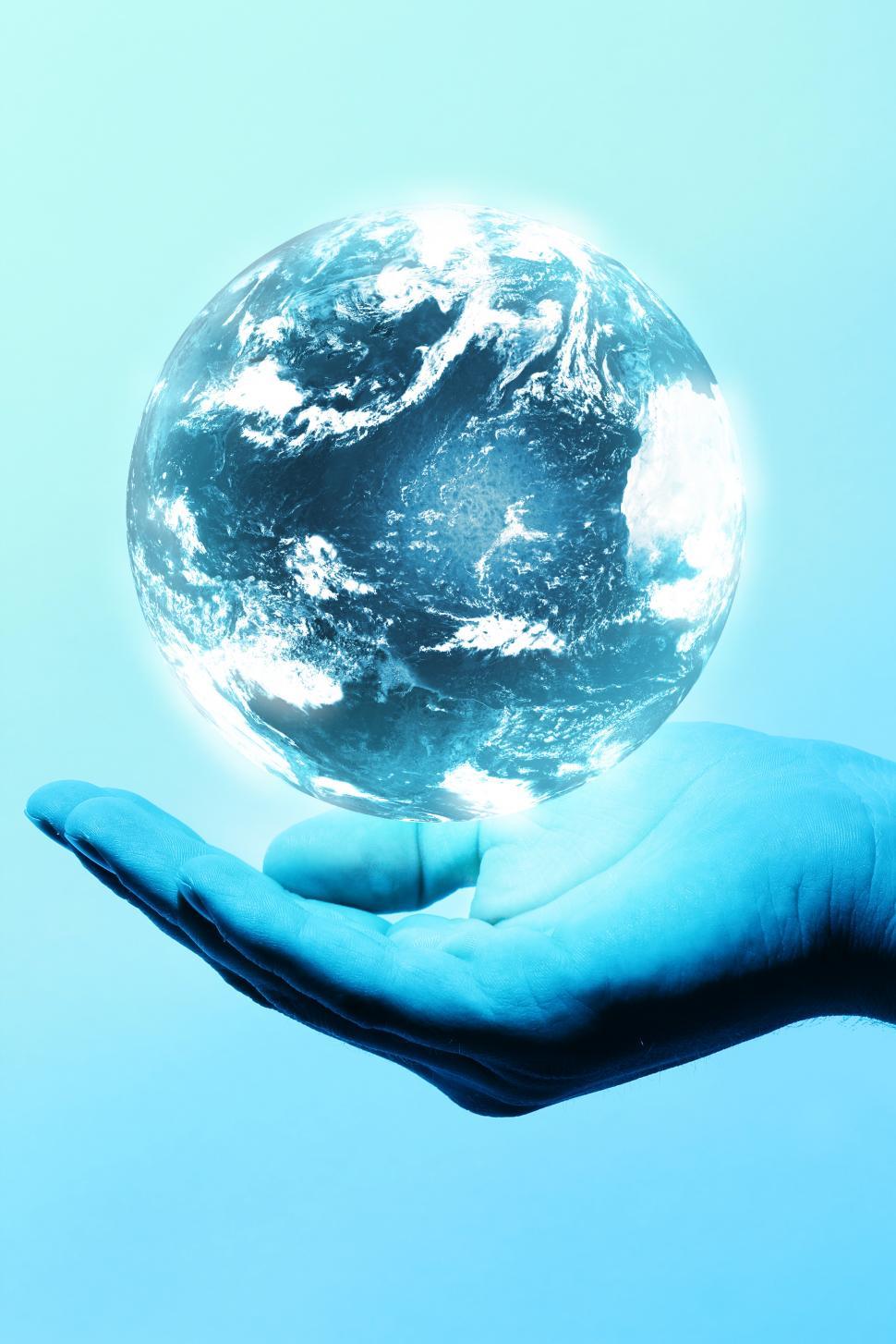 Free Stock Photo of Glowing earth sphere hovering over open hand ...