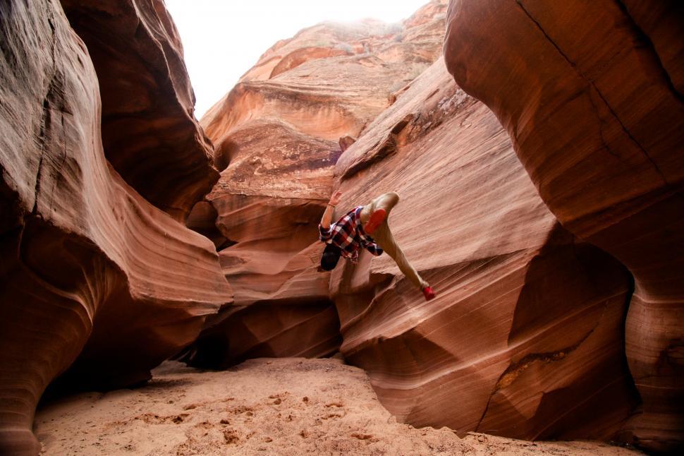 Free Stock Photo of Man jumping on textured rock stones in the cave ...