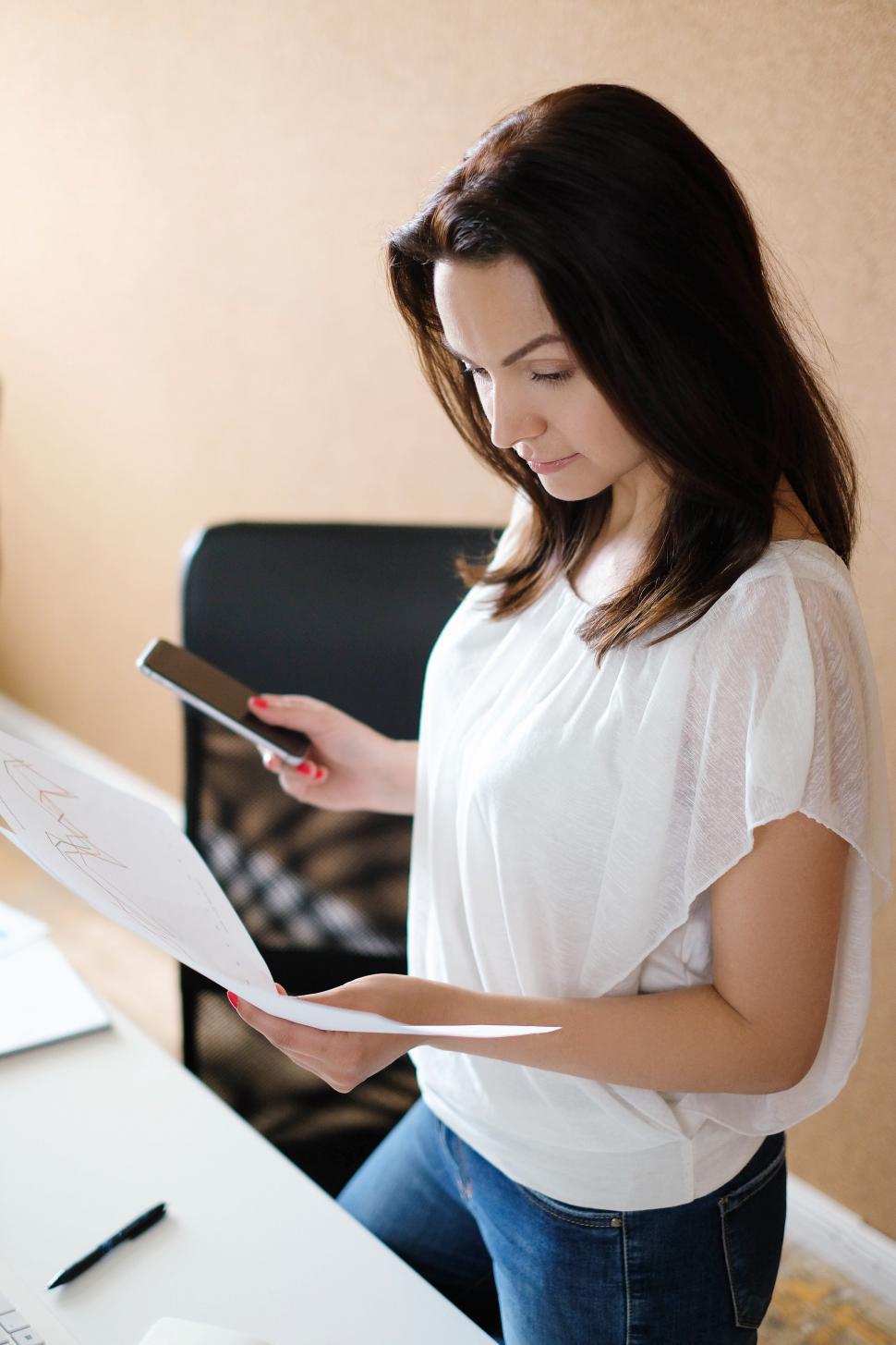 Free Stock Photo of Woman at work reviewing materials | Download Free ...