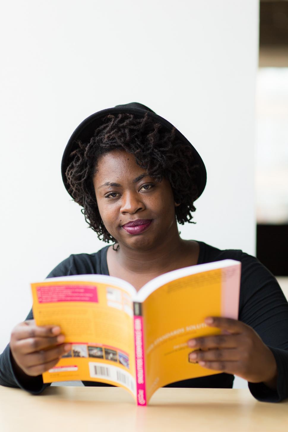 Free Stock Photo of Happy Female software developer with book ...