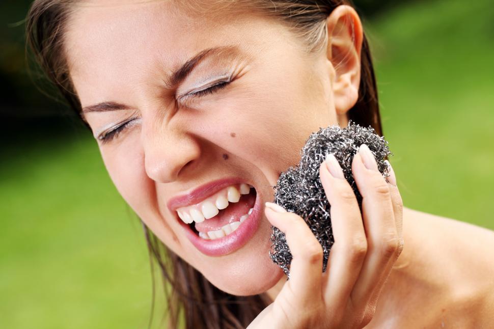 Free Stock Photo of Woman cleaning her skin with a scouring pad ...