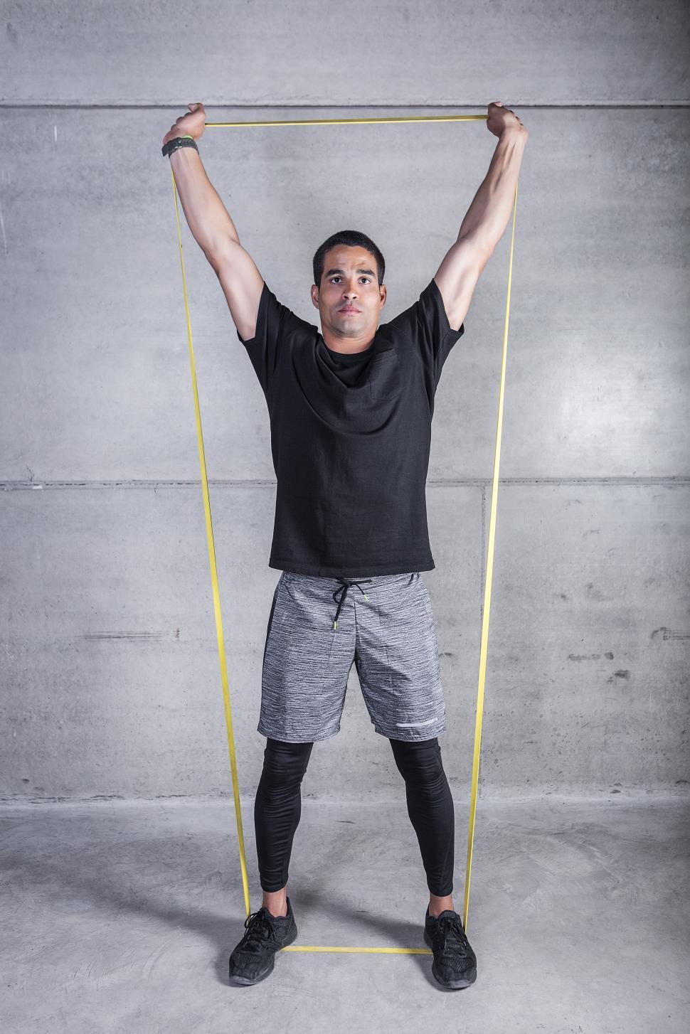 Free Stock Photo of Man with elastic band holding arms raised ...