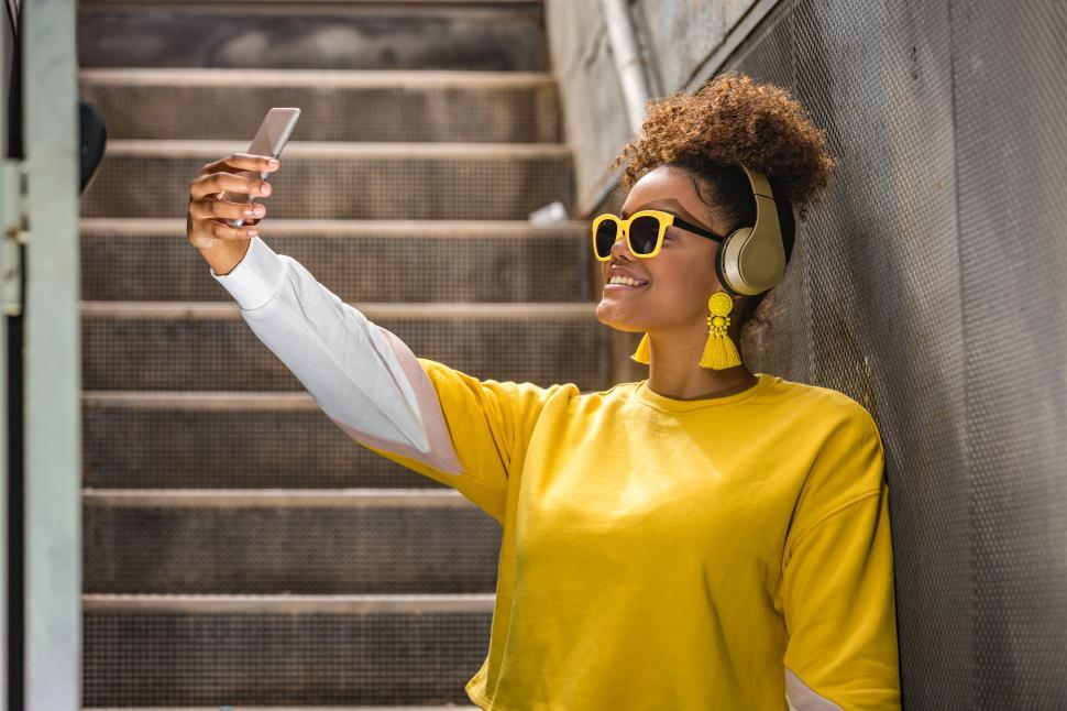 Free Stock Photo of Cheerful woman in trendy outfit taking selfie on ...