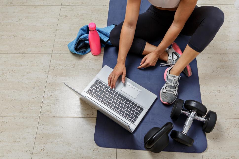 Free Stock Photo of Woman with fitness equipment using laptop at home ...